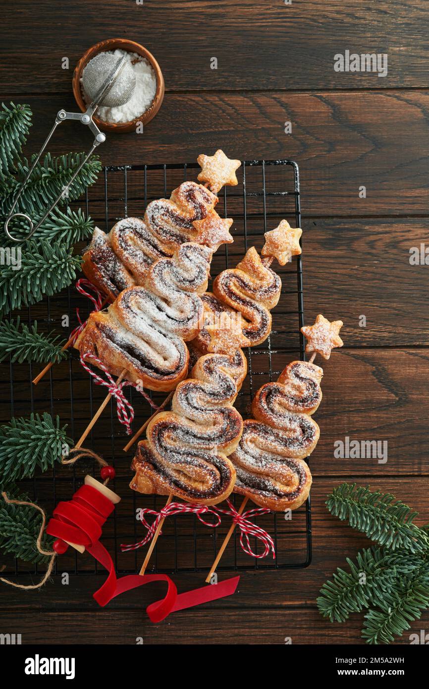 Christmas tree shape puff pastry cakes with chocolate filling, sugar ...