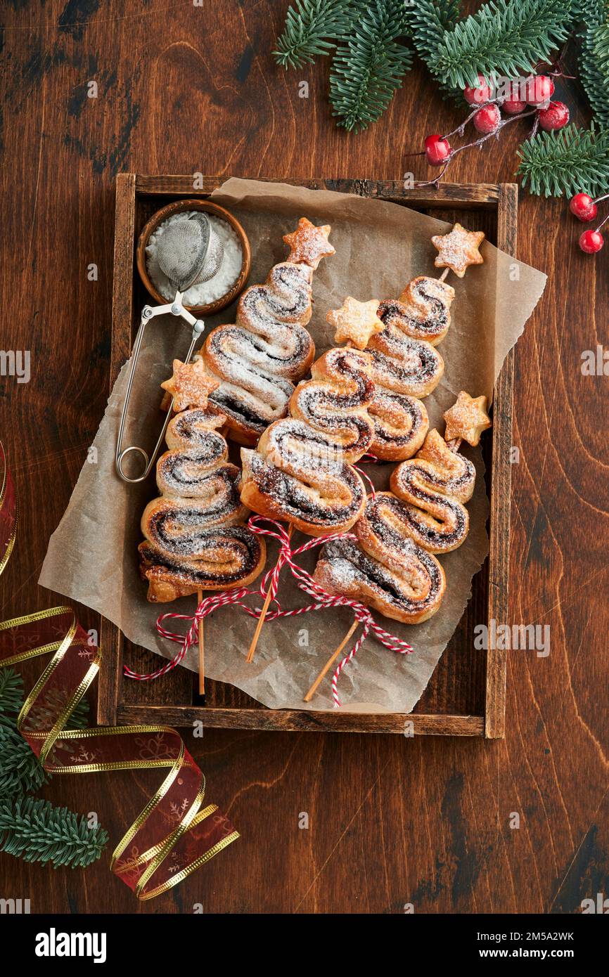 Christmas tree shape puff pastry cakes with chocolate filling, sugar ...
