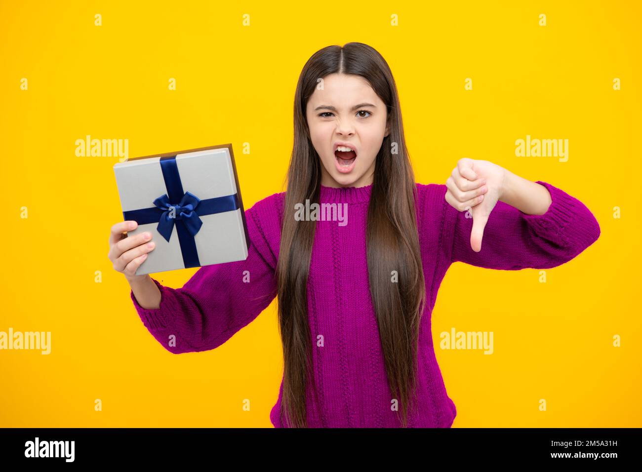 Angry face, upset emotions of teenager girl. Child teen girl with gift ...