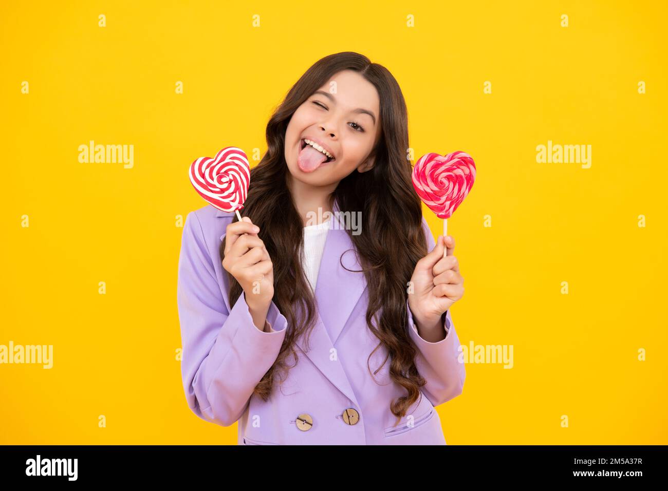 Funny face. Teenager girl with caramel candies on sticks, sweet sugar ...
