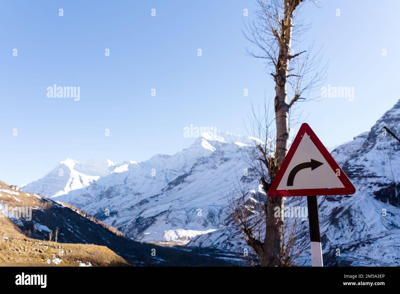 Road sign warning against slippery road due to snow ice Stock Photo - Alamy