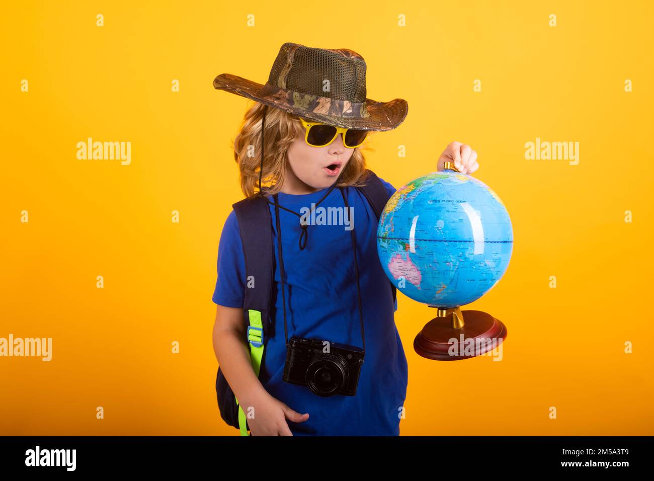 Child with backpack and camera, explorer. Concept of exploration and ...