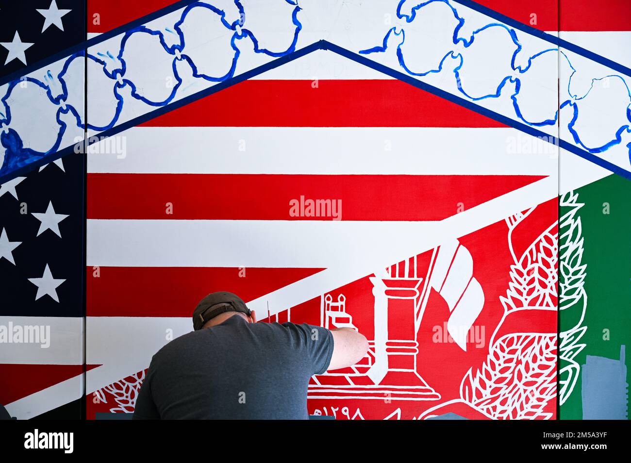 Members of Task Force Liberty work with guests to paint a mural ...