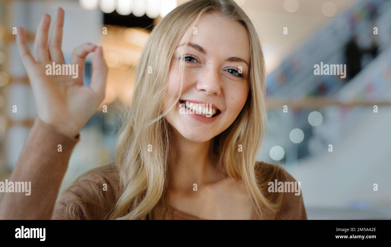 Close-up young girl smiling showing gesture sign OK caucasian woman ...