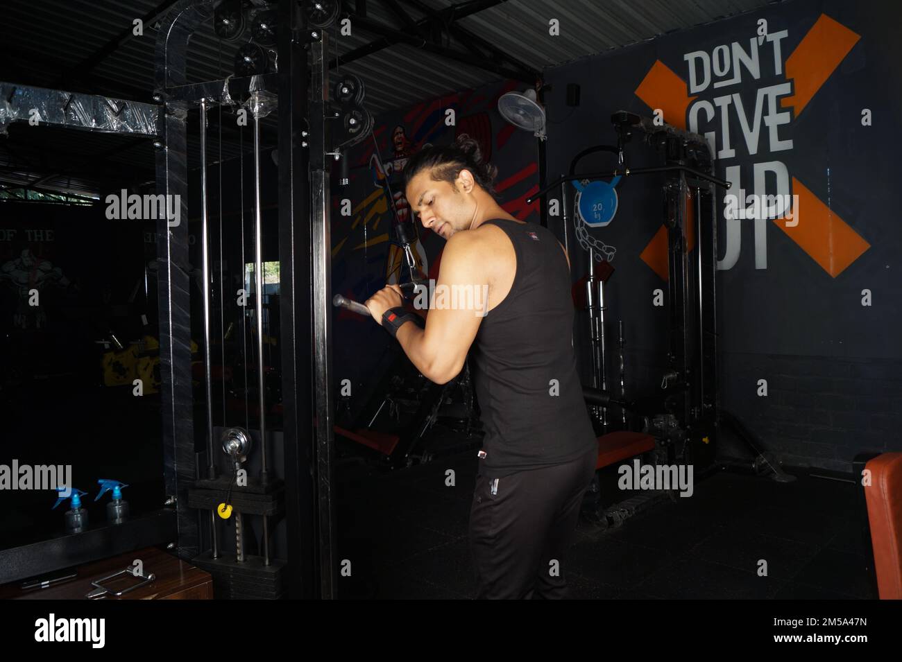 An Indian male doing lifting exercises at the gym Stock Photo - Alamy