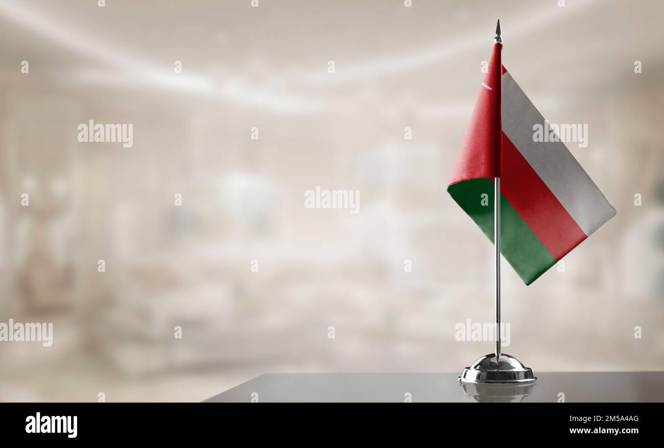 A small Oman flag on an abstract blurry background Stock Photo - Alamy