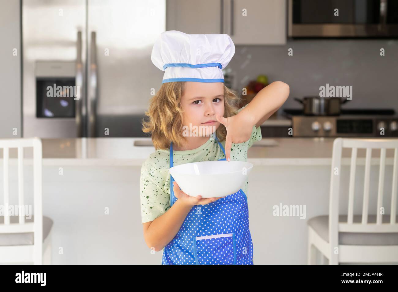 Child chef cook with cooking plate. Child in chef hat and apron ...