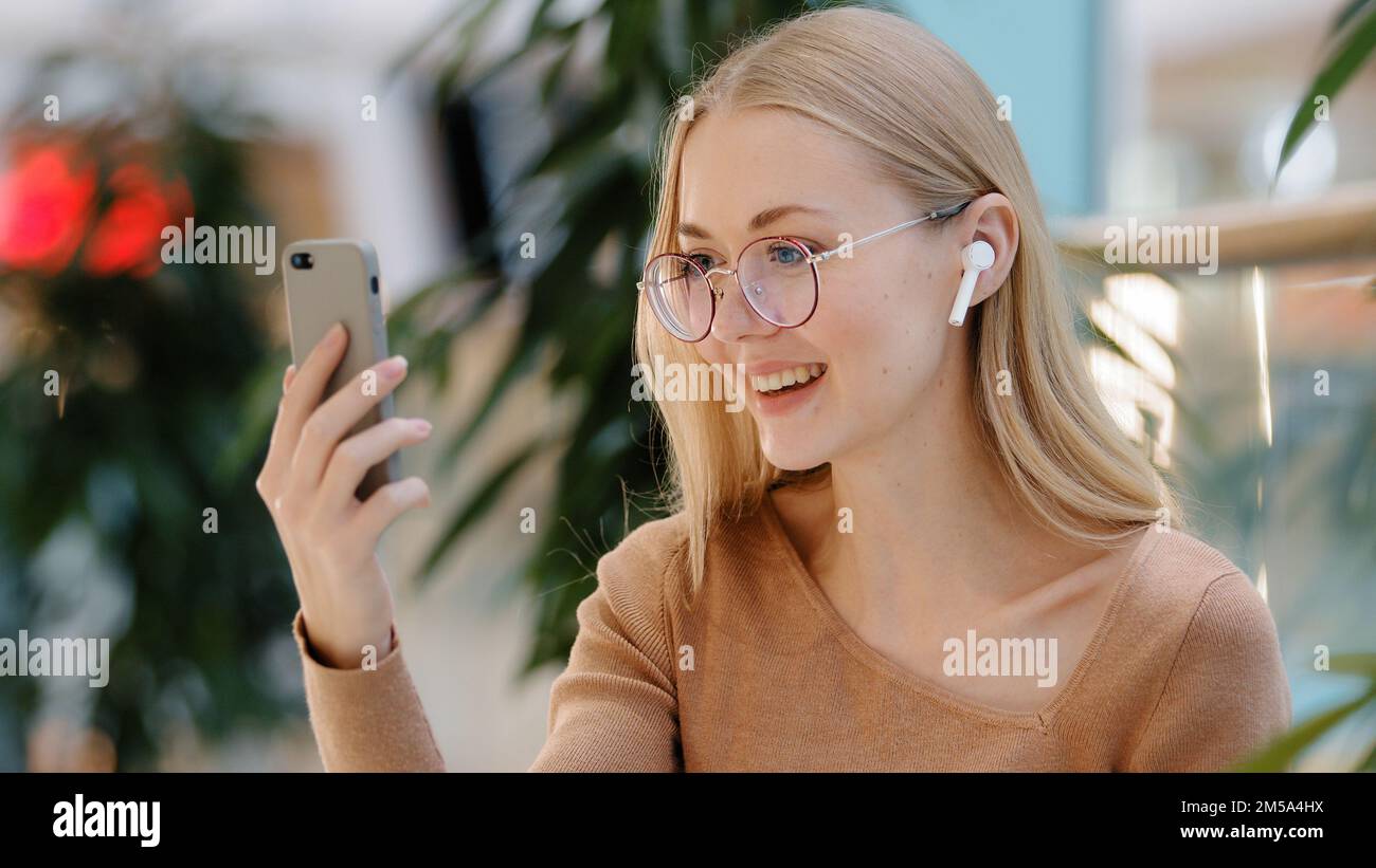 Close-up side view caucasian woman girl blogger wears wireless ...