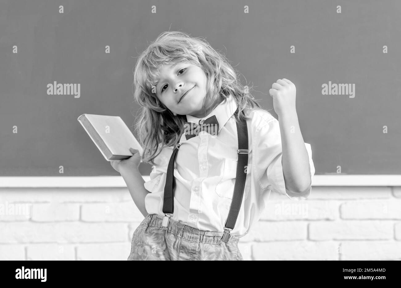 nerd kid with long hair at blackboard. september 1. childhood ...