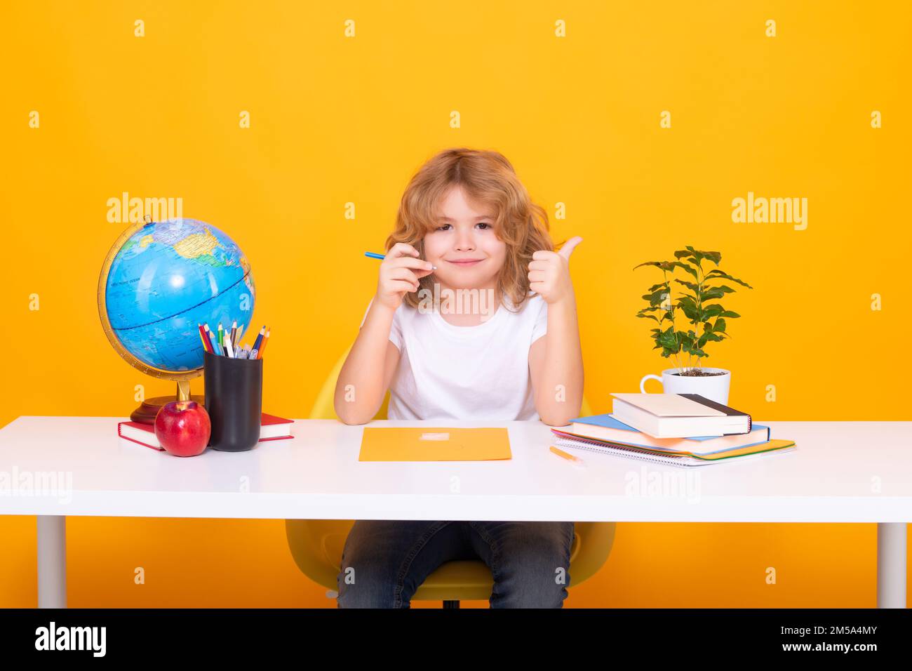 Child writing lesson. Little student school child isolated on studio ...