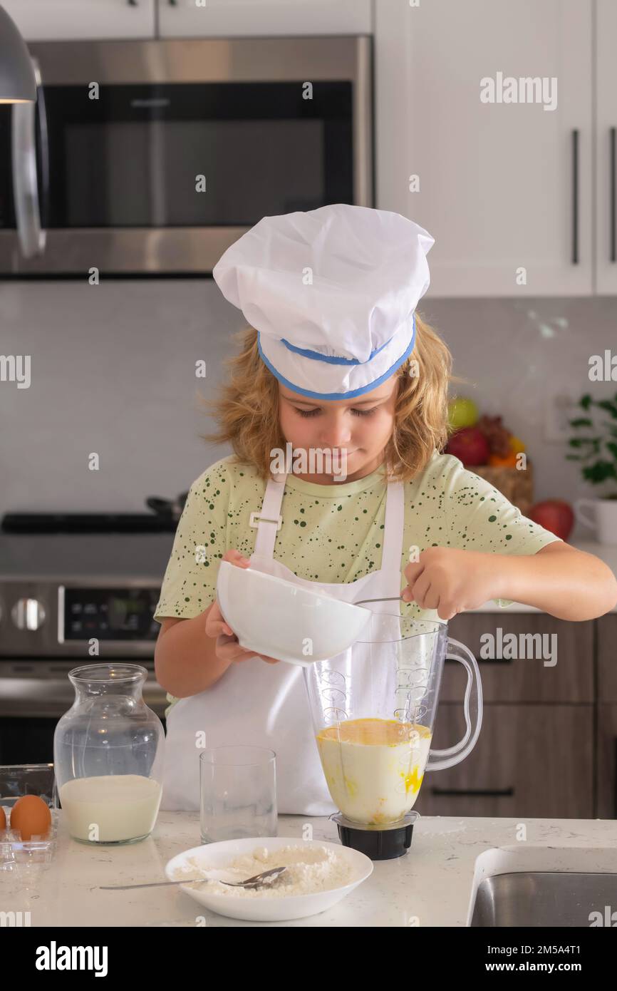 Children cooking in the kitchen. Funny kid chef cook cookery at kitchen ...