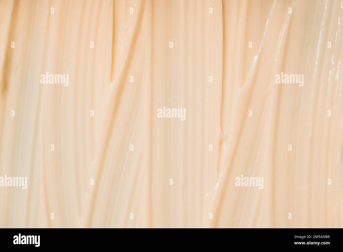 Yellow cream or lotion texture as background with copy space for text ...
