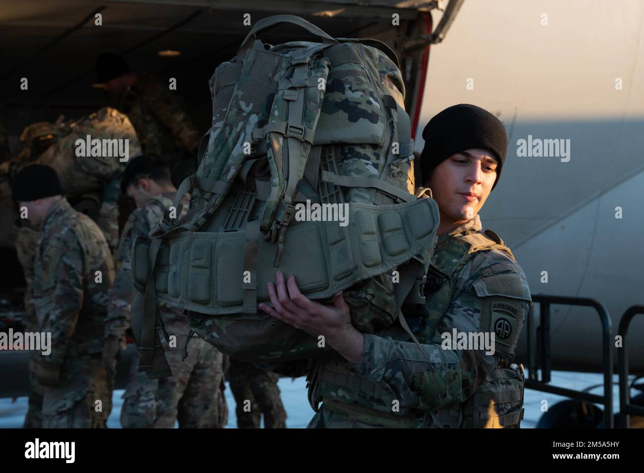 A U.S. Army soldier assigned to the 82nd Airborne Division handles gear at Rzeszów-Jasionka ...