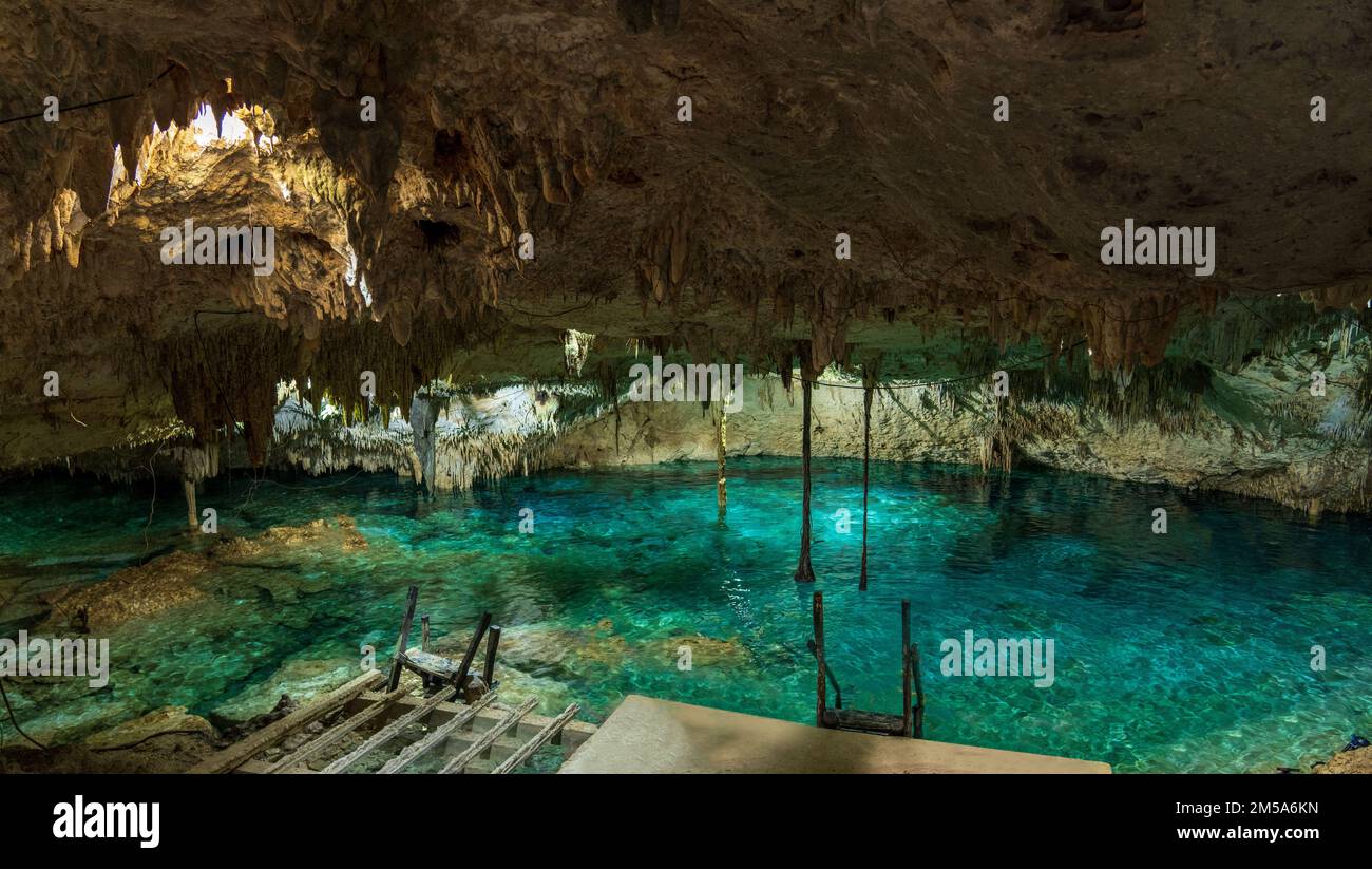 A pond in a cave with lights Stock Photo - Alamy