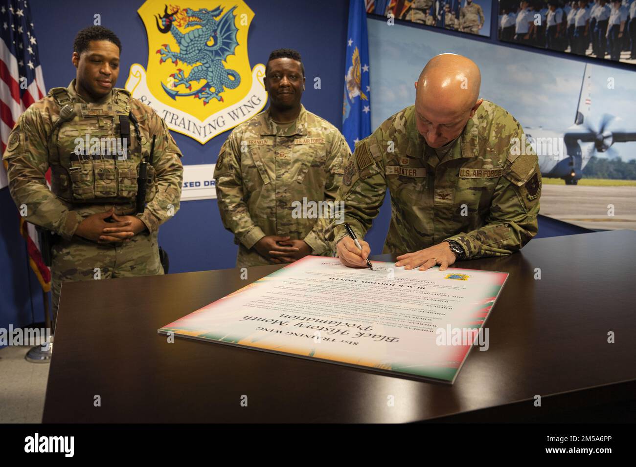 U.S. Air Force Col. William Hunter, 81st Training Wing commander, signs ...