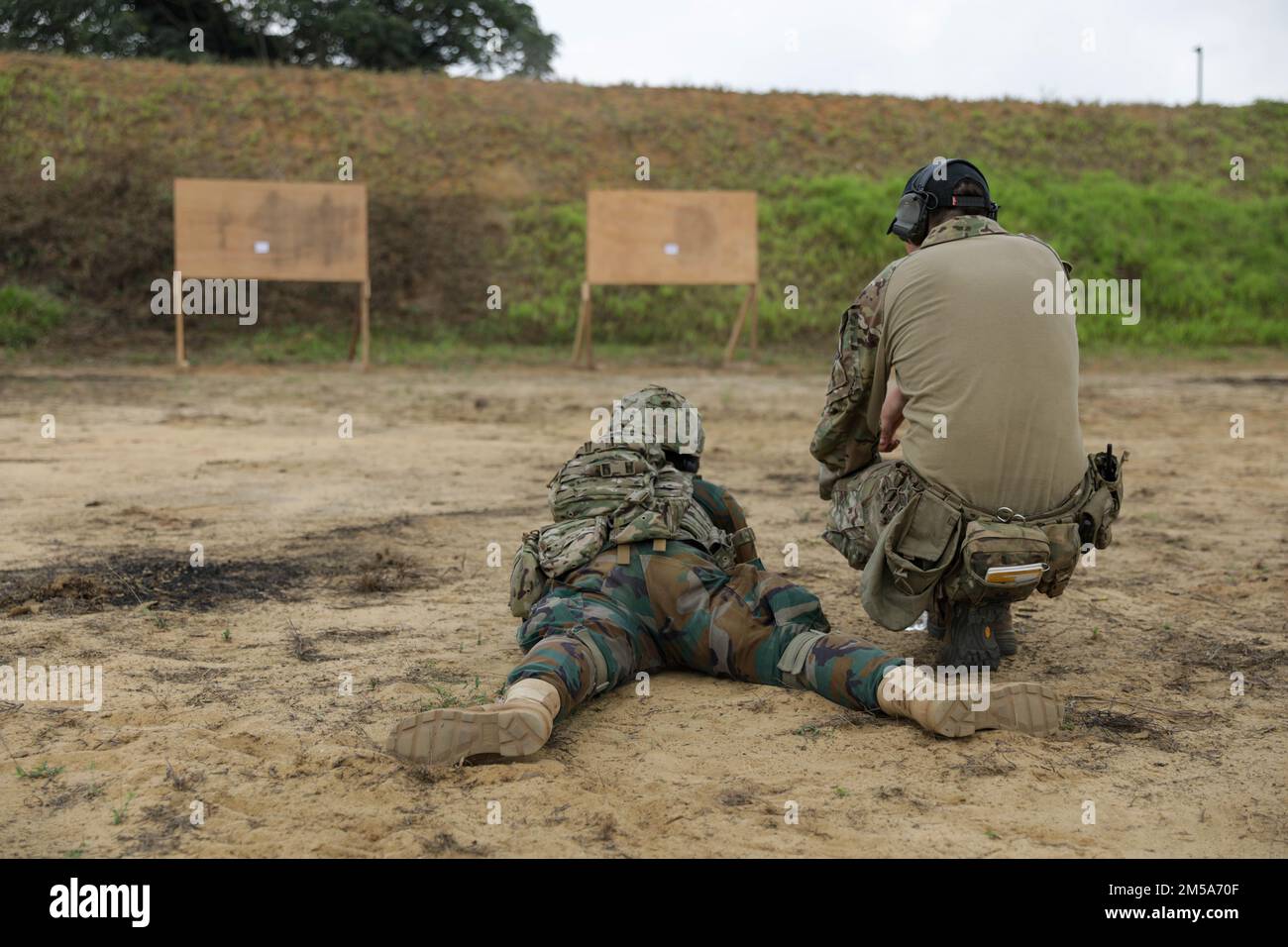 A British Armed Forces Soldier coaches a Ghana Army Soldier during a ...