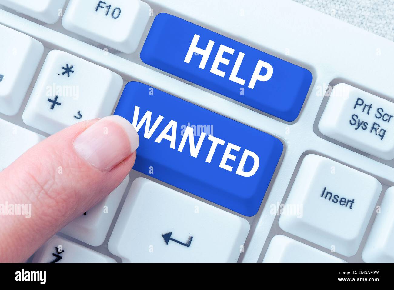 Hand writing sign Help Wanted. Word for advertisement placed in ...