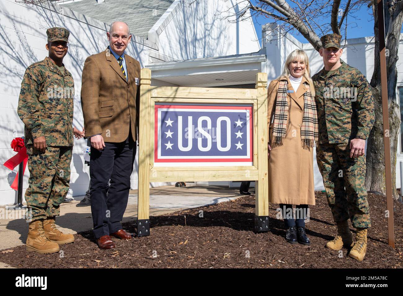 Honored guests pose for a picture after the ribbon cutting ceremony ...