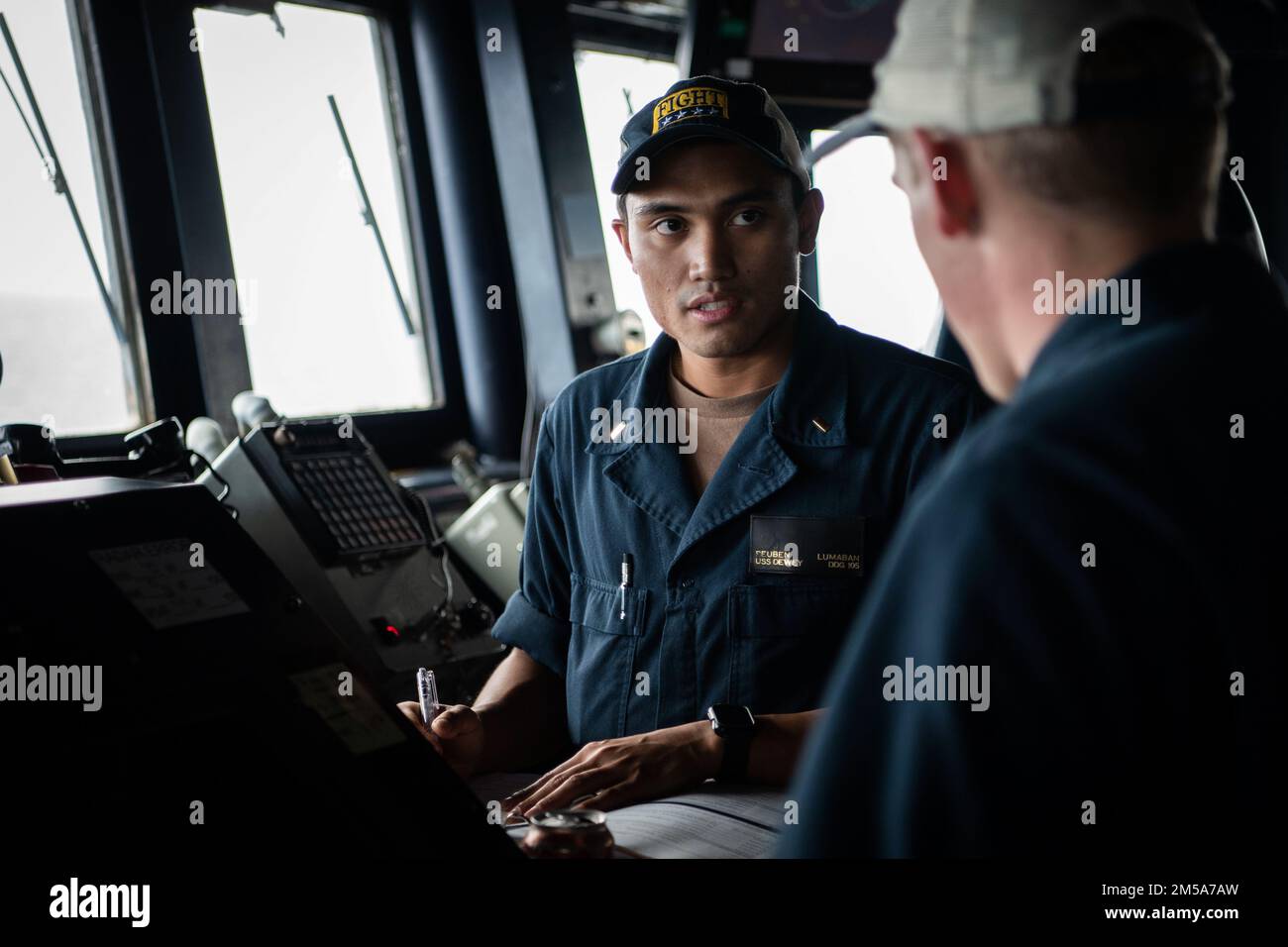 SOUTH CHINA SEA (Feb. 15, 2022) Ensign Reuben Lumaban, left, from Port ...