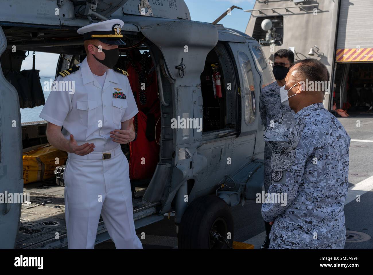 220215-N-FA490-1112 MANILA, Philippines (Feb. 15, 2022) – Lt. Cmdr. Mike Feay, left, from ...