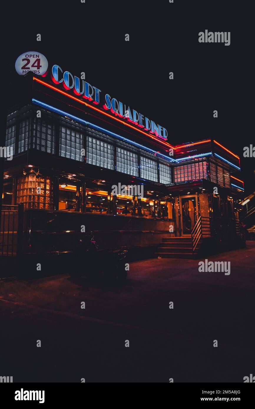 A vertical shot of neon light sign of illuminated Court Square Diner ...