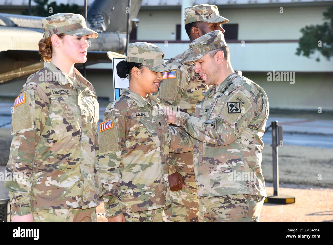 Army Col. Marc Welde, 32d Medical Brigade Commander, pins a tab ...