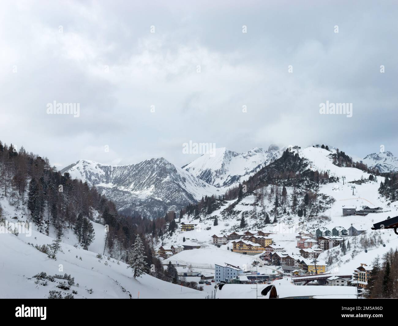 Buildings in the small town in the valley. The snowy mountains of the ...