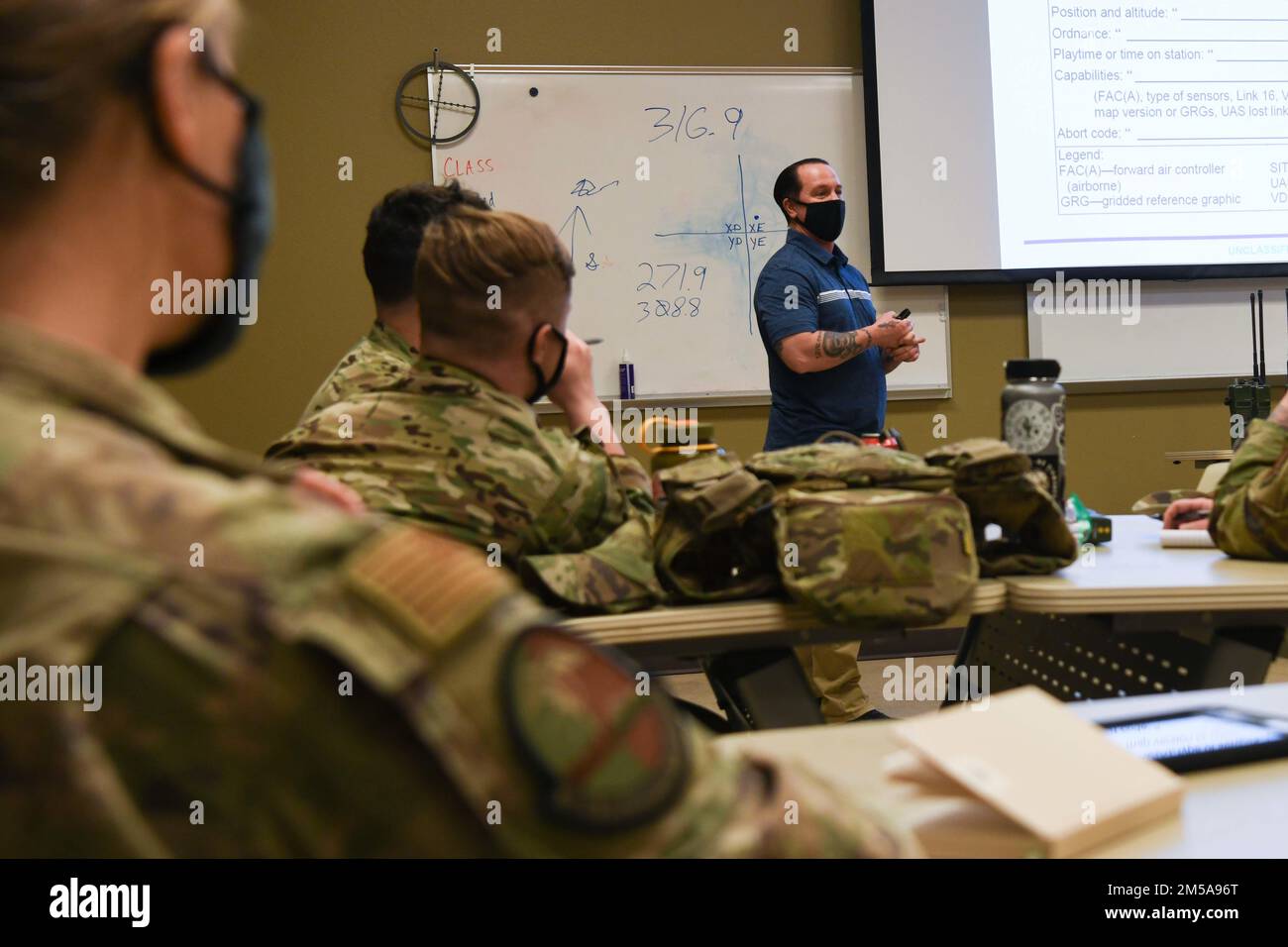 William Abel, Fire Observers course instructor, instructs Airmen ...