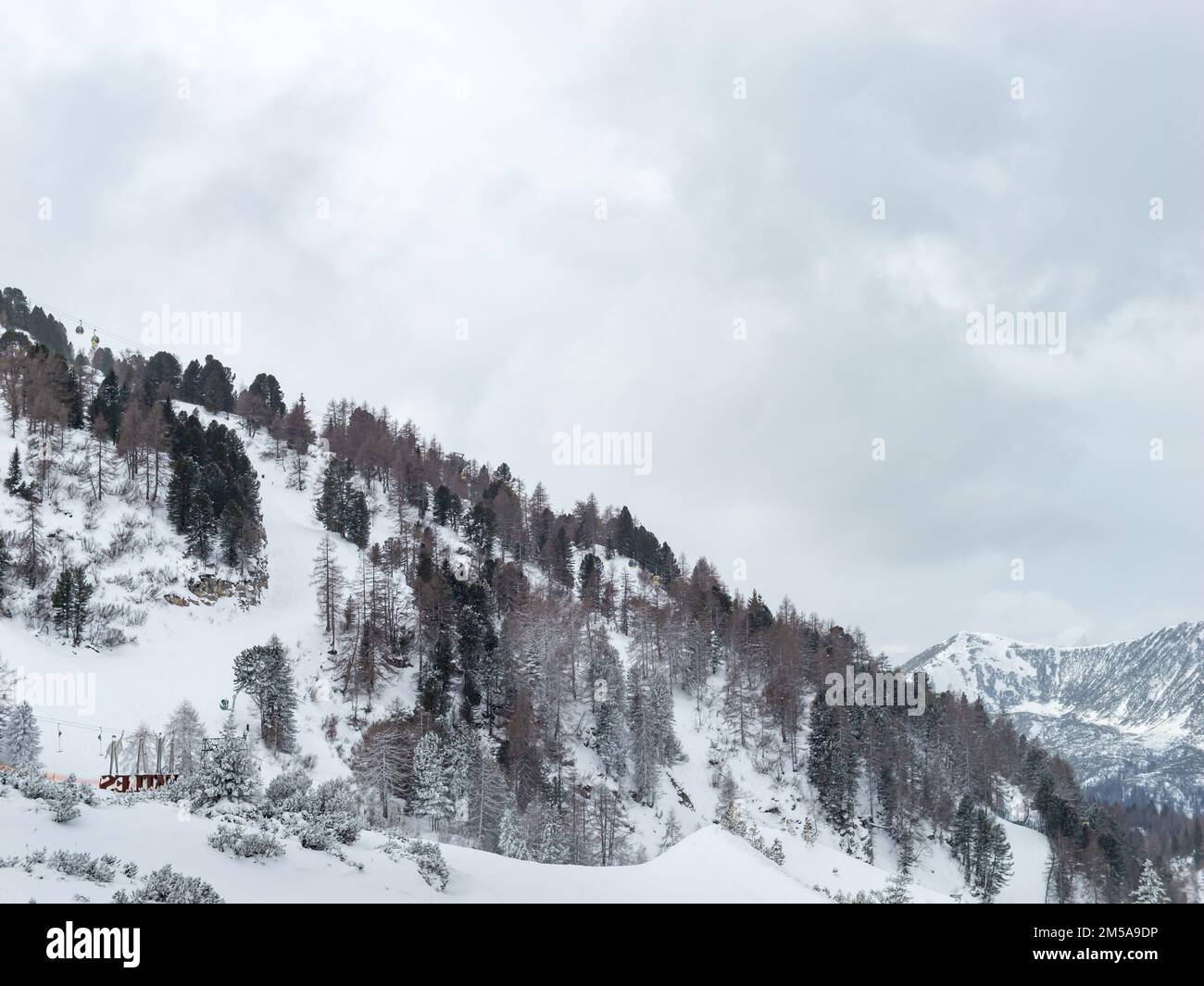 Landscape with snowy mountains of a winter sport resort. A steep slope ...