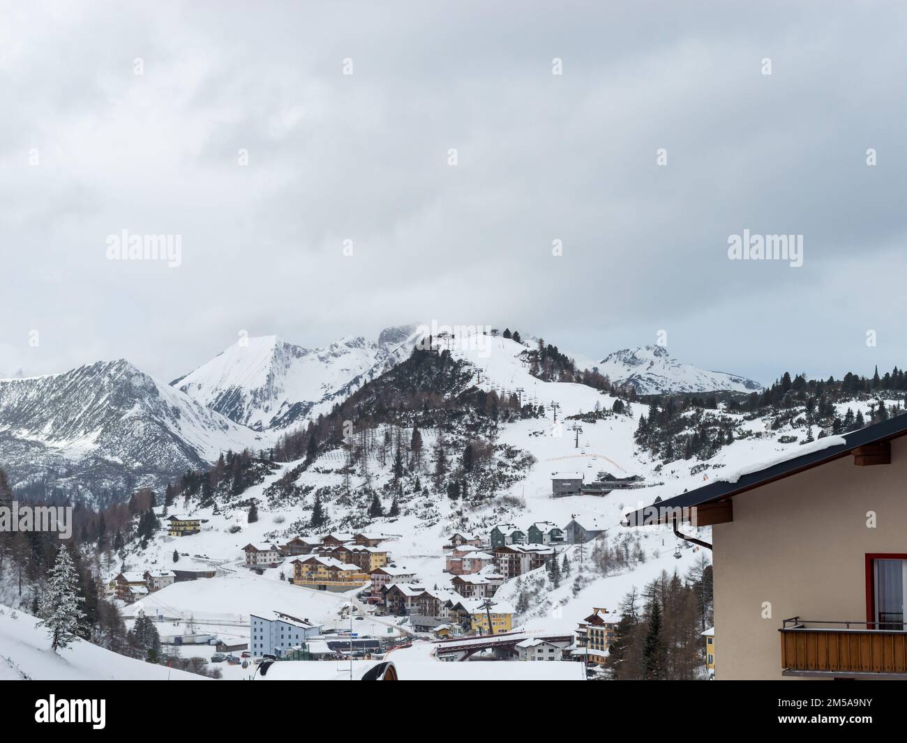 Buildings in the small town in the valley. The snowy mountains of the ...