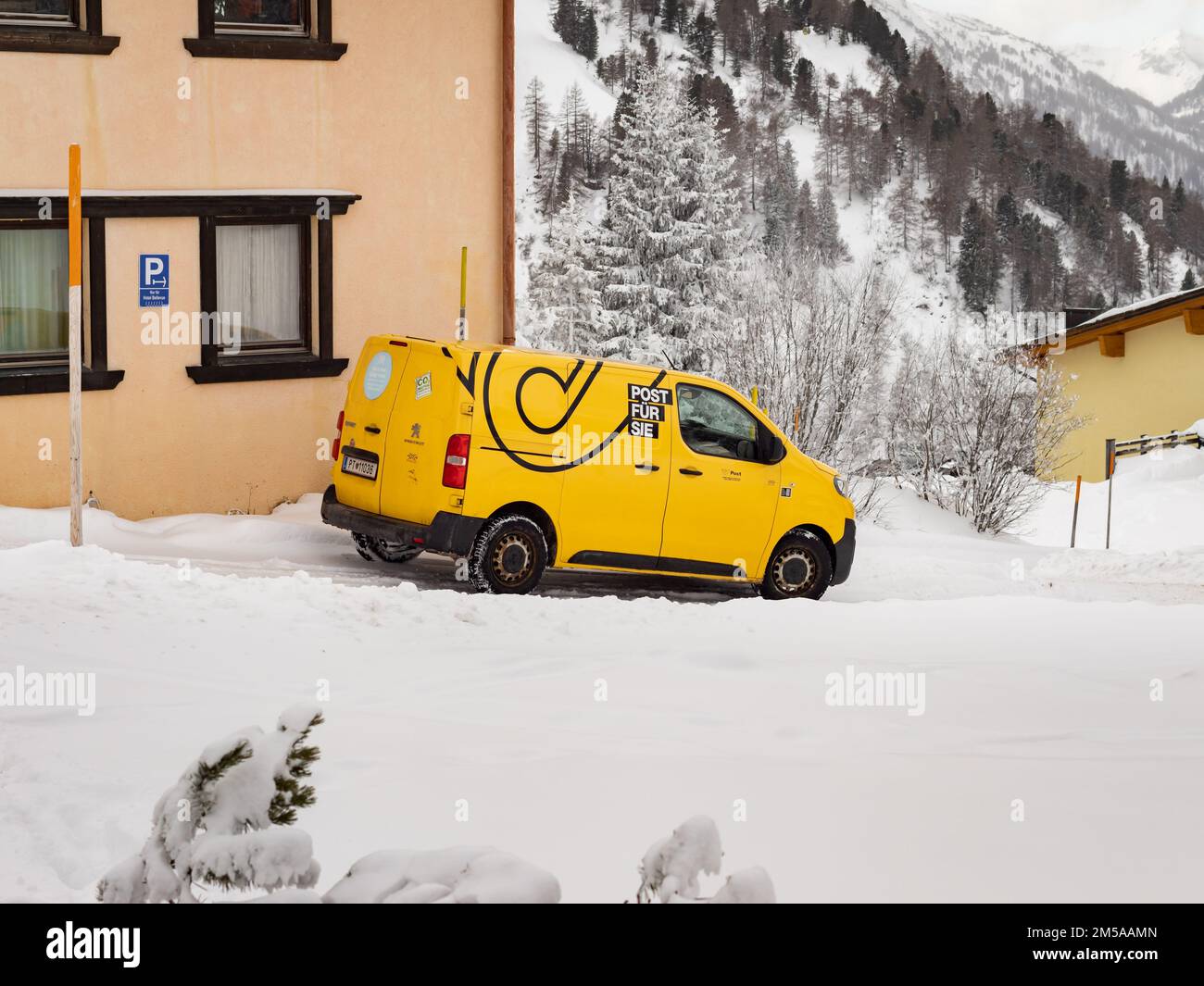 Österreichische Post (postal service in Austria) car on a winter street ...