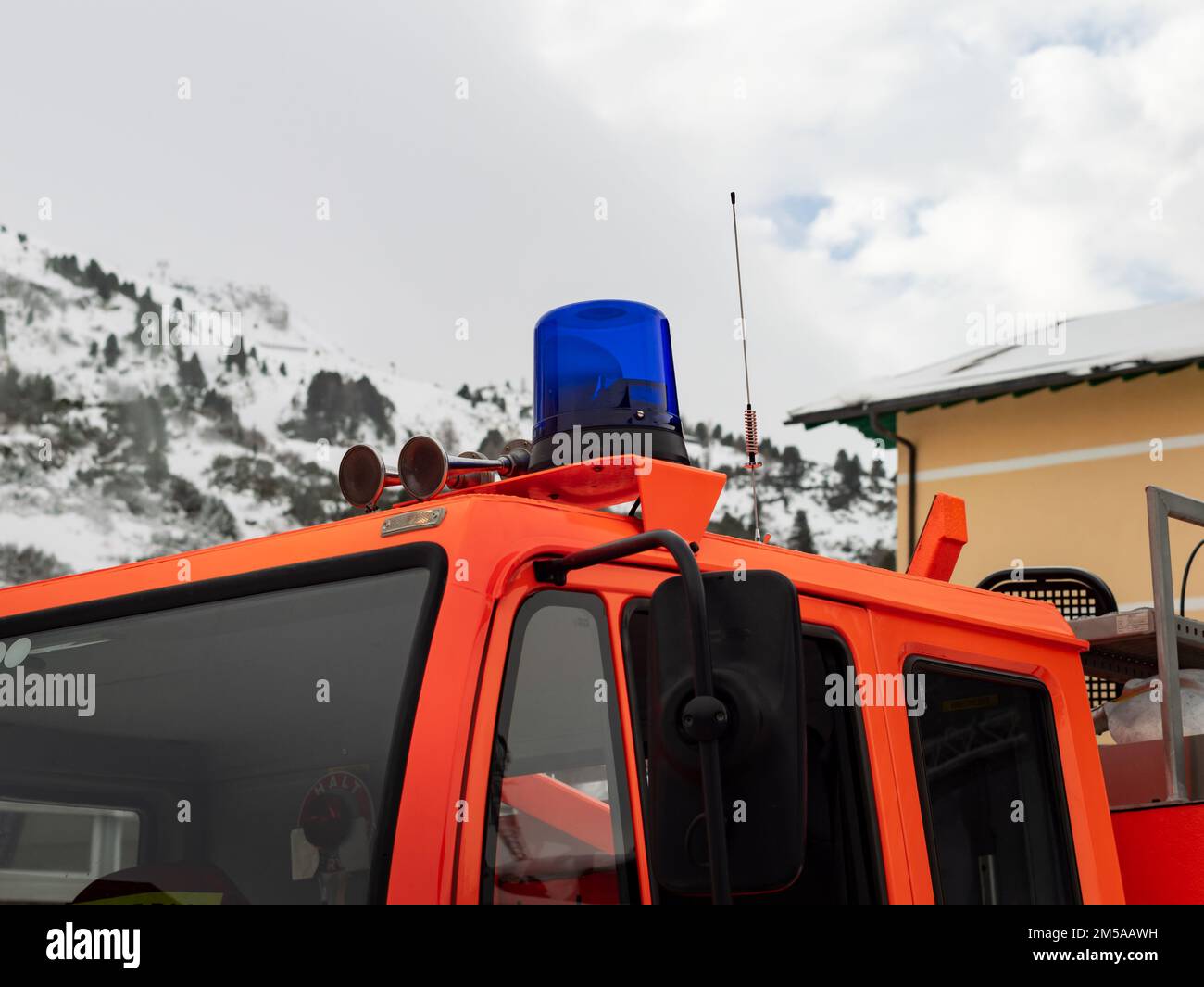 Blue rotating beacon light on an orange fire engine. Rooftop of a fire ...