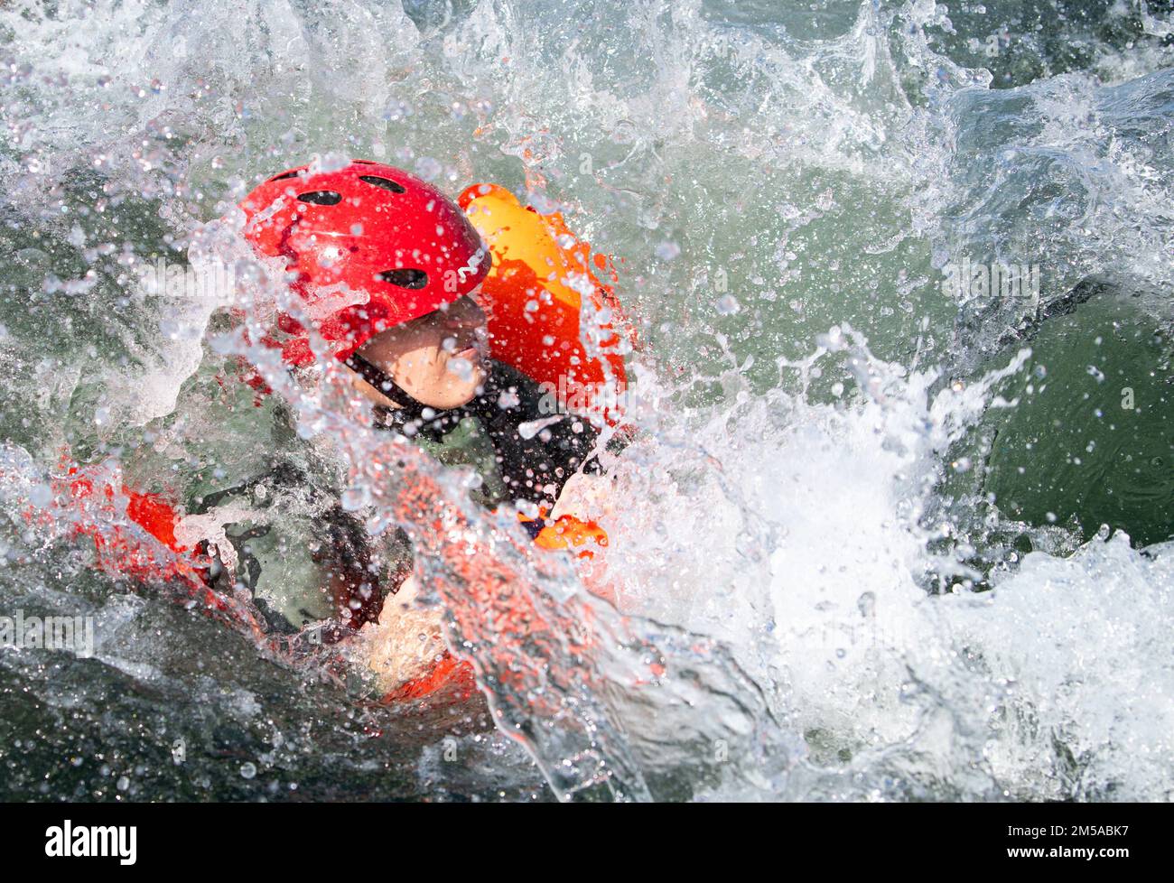 A Water Survival Training participant jumps into the water to exit a ...