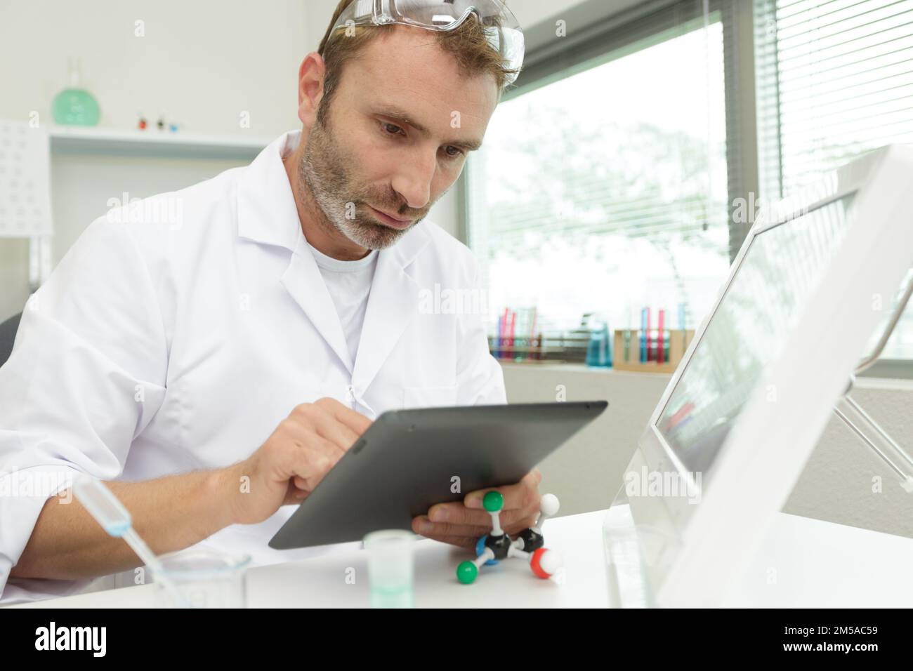 technician man using a tablet in the lab Stock Photo - Alamy