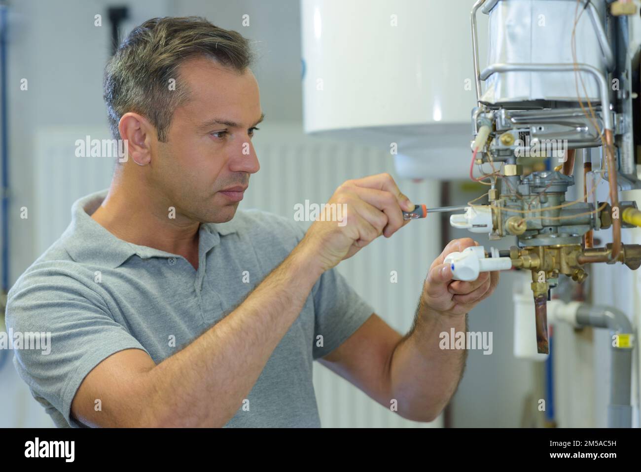 Engineer fixing a boiler hi-res stock photography and images - Alamy