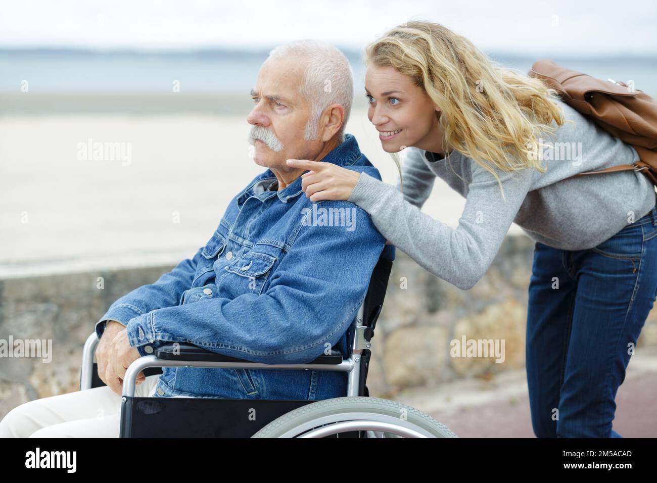 woman and senior man in wheelchair Stock Photo - Alamy