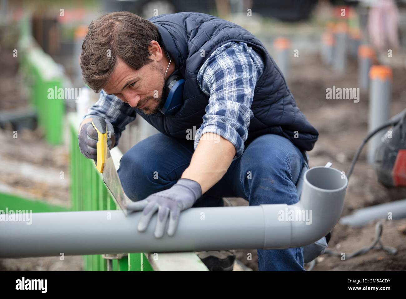 industrial worker sawing copper pipe Stock Photo - Alamy