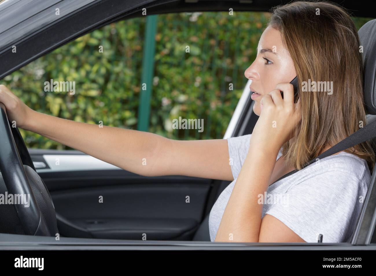 female driver using her telephone while driving Stock Photo - Alamy