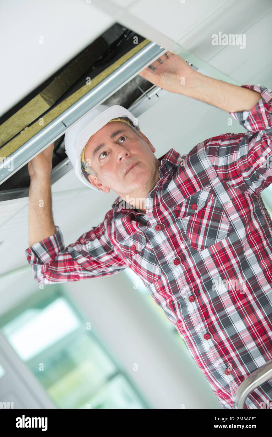 construction worker working on ceilings Stock Photo - Alamy