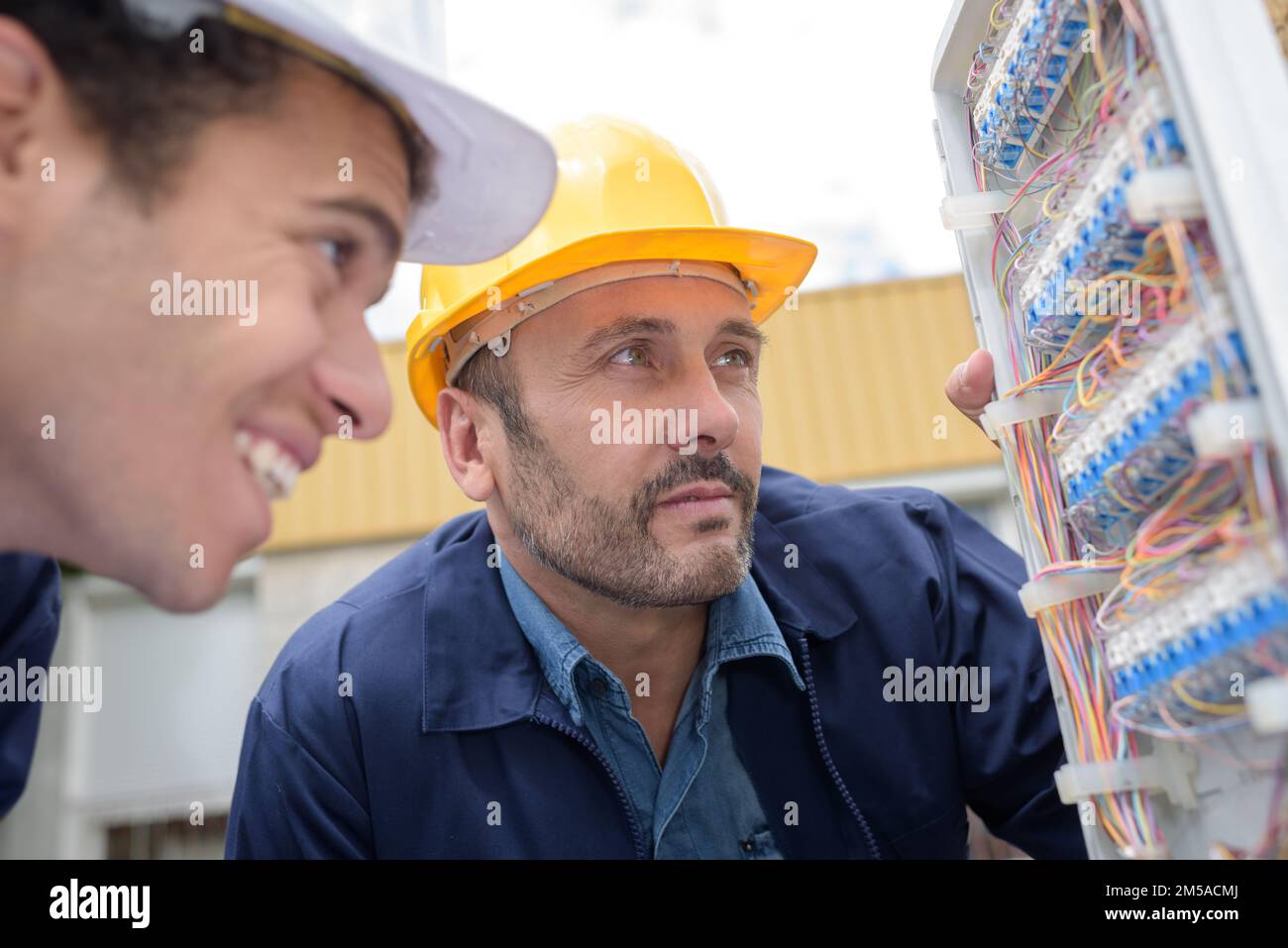 two electrician workers at cabling Stock Photo - Alamy