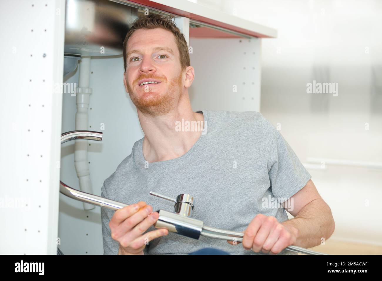Man repairing plumbing under hi-res stock photography and images - Alamy