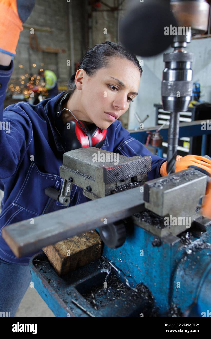 woman operating drilling machine concentrating on her job Stock Photo ...