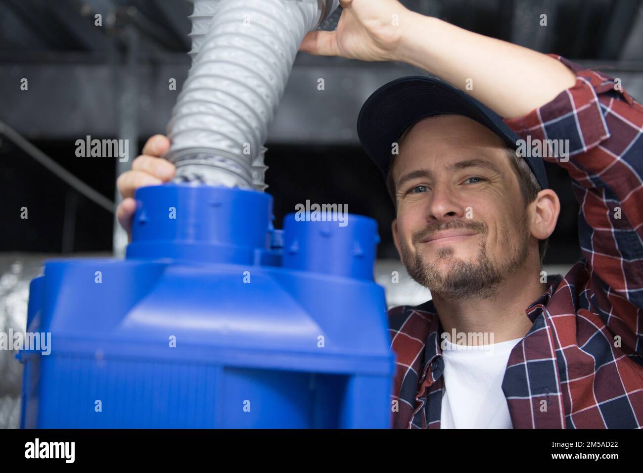 electrical worker with ventilation pipes Stock Photo - Alamy