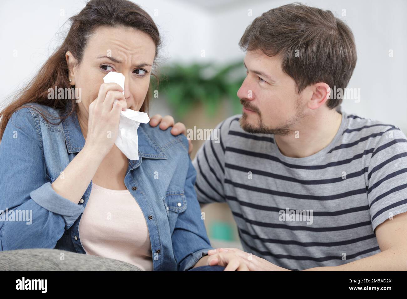 upset crying woman and loving boyfriend trying to comfort her Stock ...