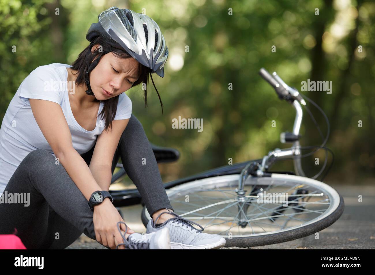 female cyclist has ankle injury after falling from her bicycle Stock ...
