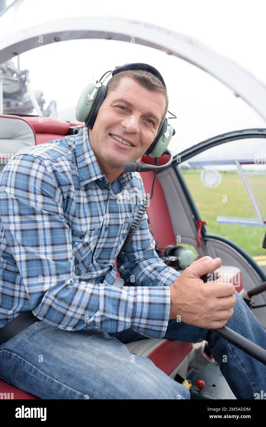 portrait of pilot standing in helicopter Stock Photo - Alamy