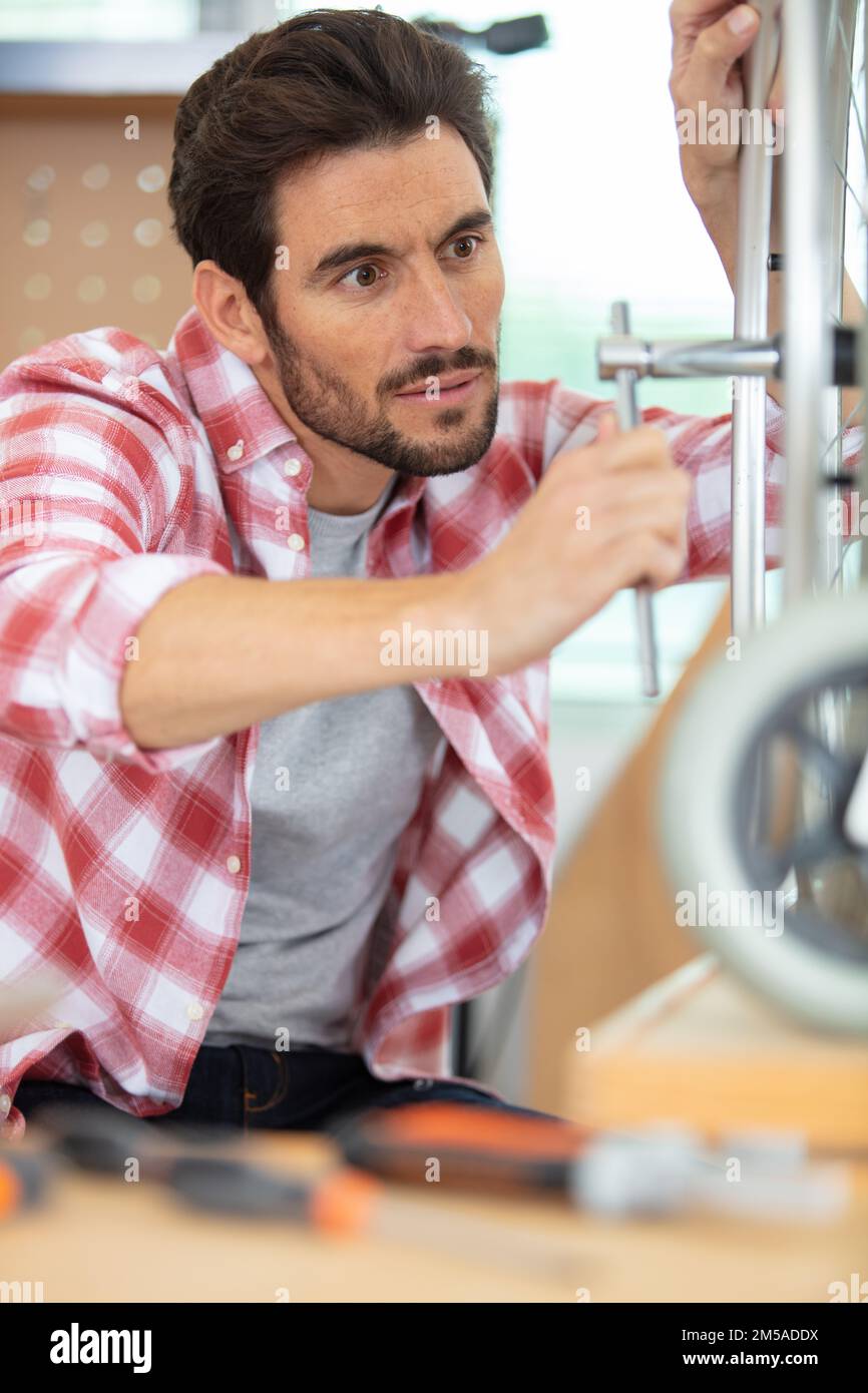 man working in cycle repair shop Stock Photo - Alamy