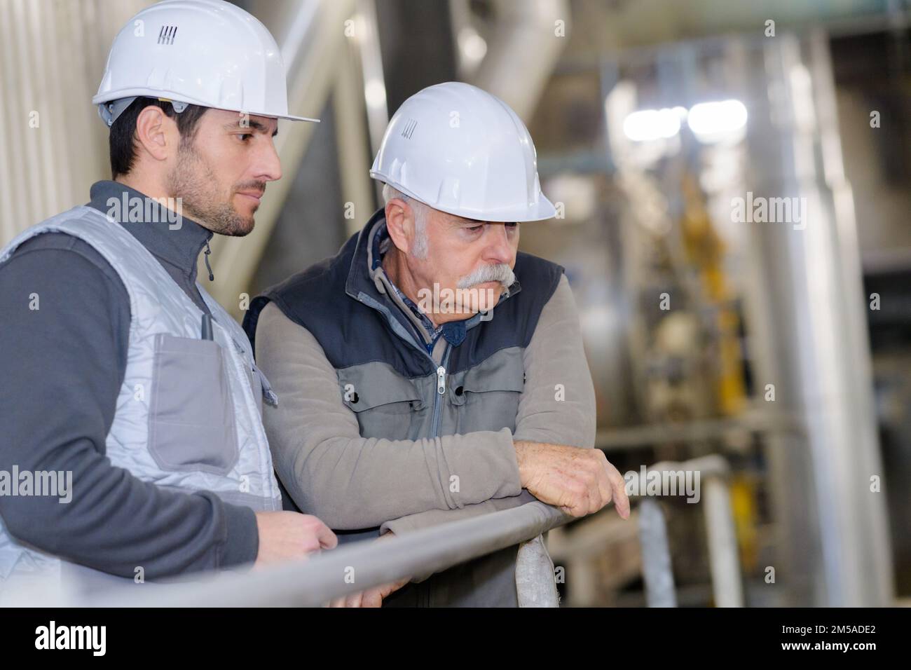 Plant workers operating cnc machine hi-res stock photography and images ...