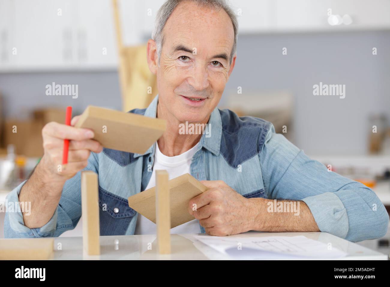 a senior man assembling furniture Stock Photo - Alamy