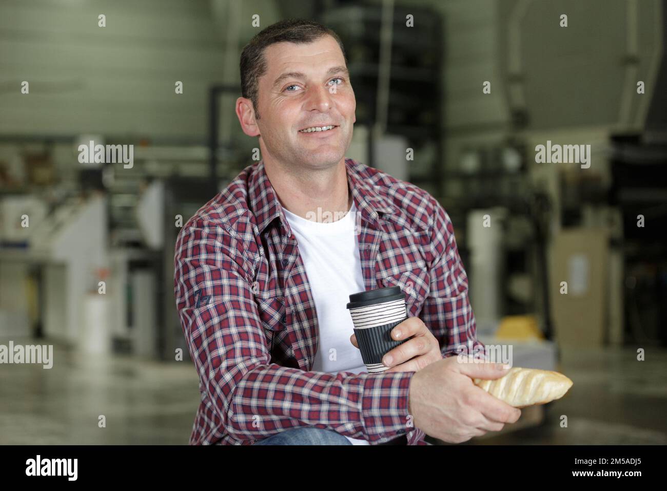 cnc machine operator having a coffee brake in industrial factory Stock ...